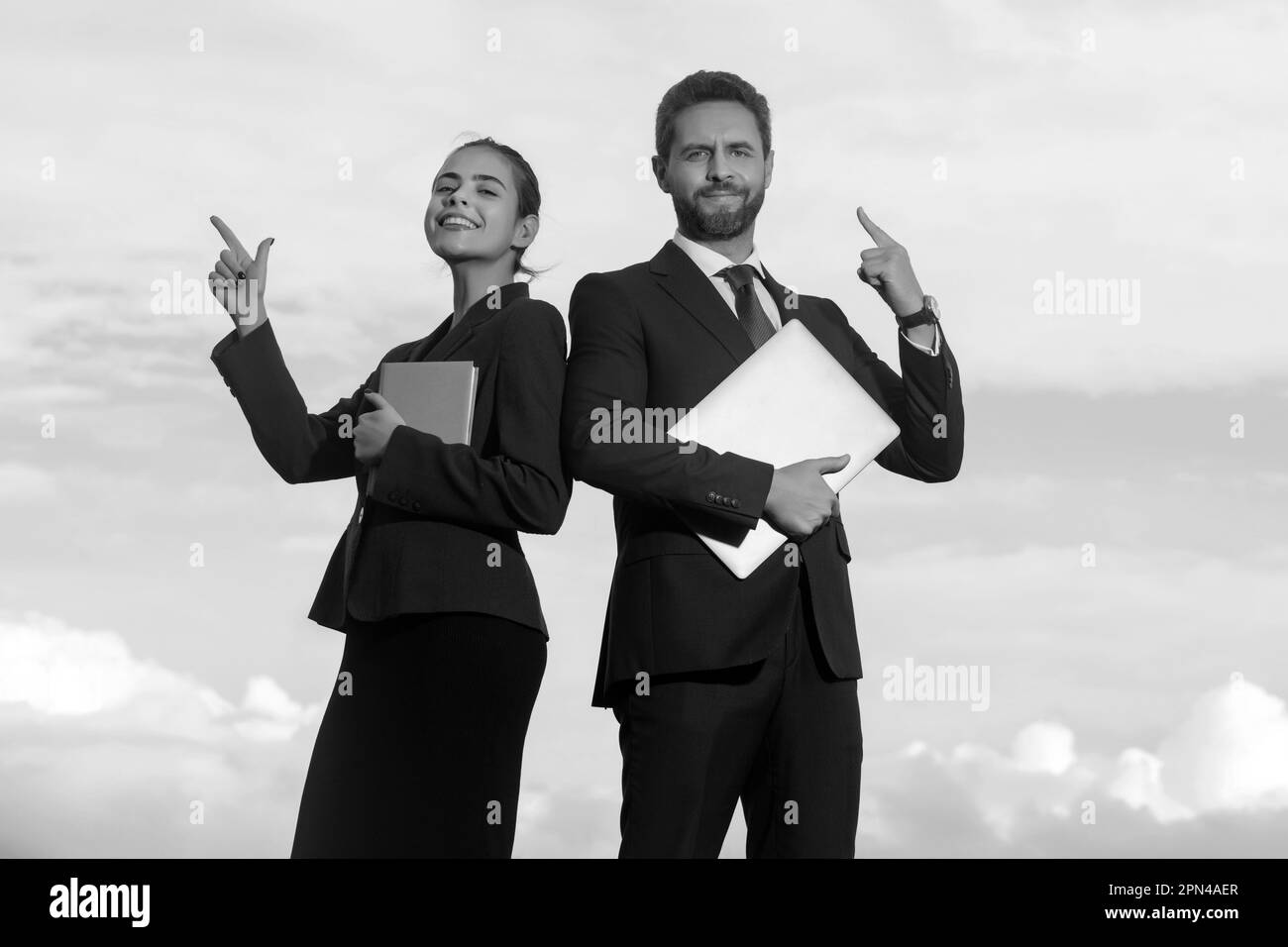 Successful business couple. Successful business people standing over ...