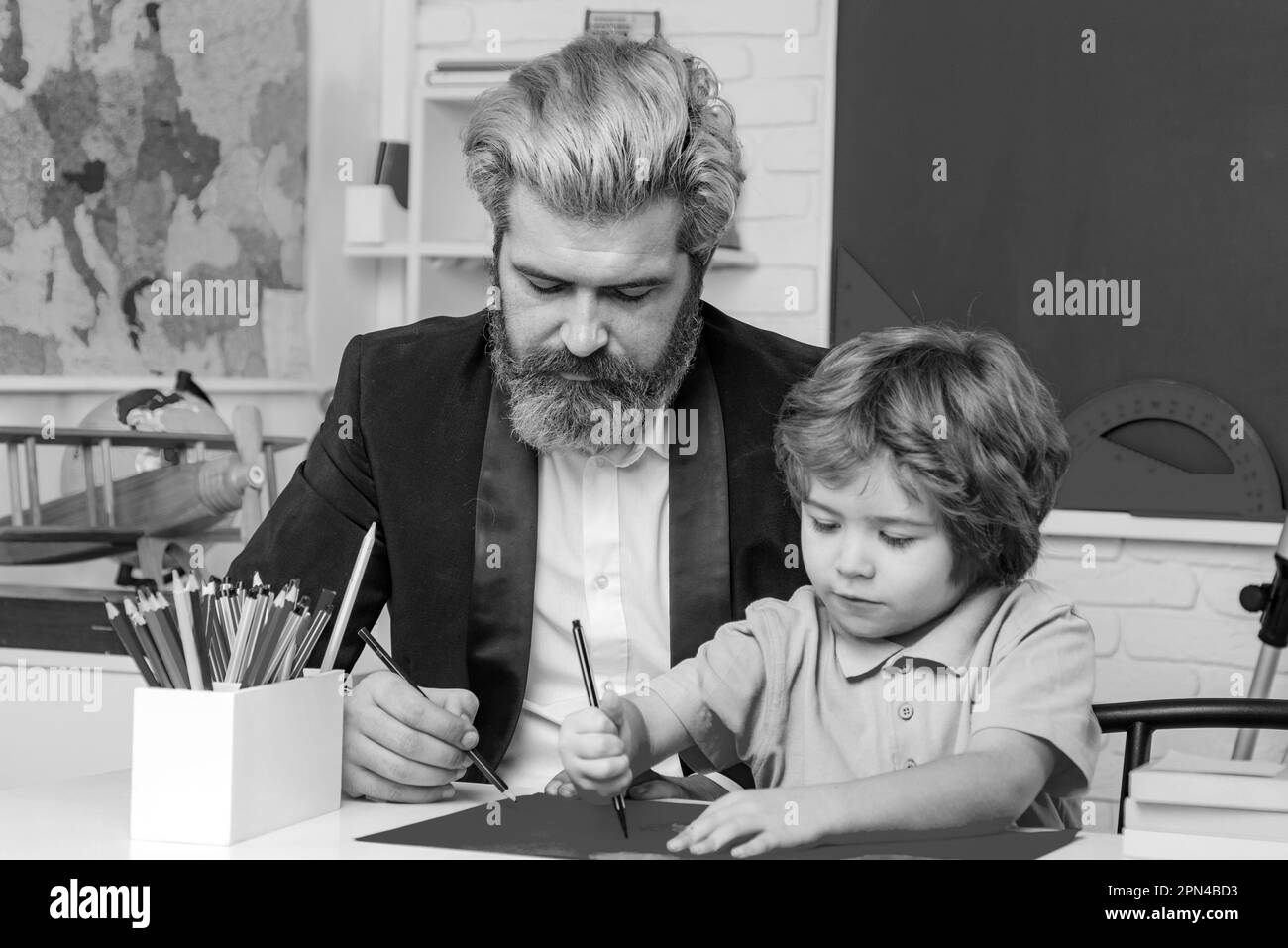 Father teaching son. Father and son together schooling. Kid and teacher ...