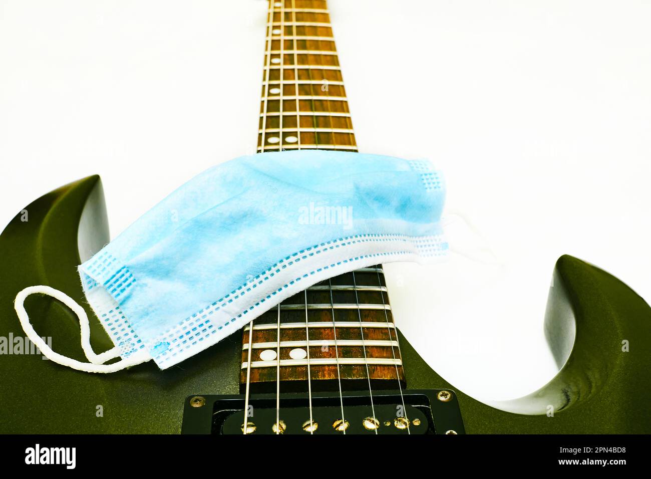 Blue protective mask on the fretboard of a black electric guitar Stock ...