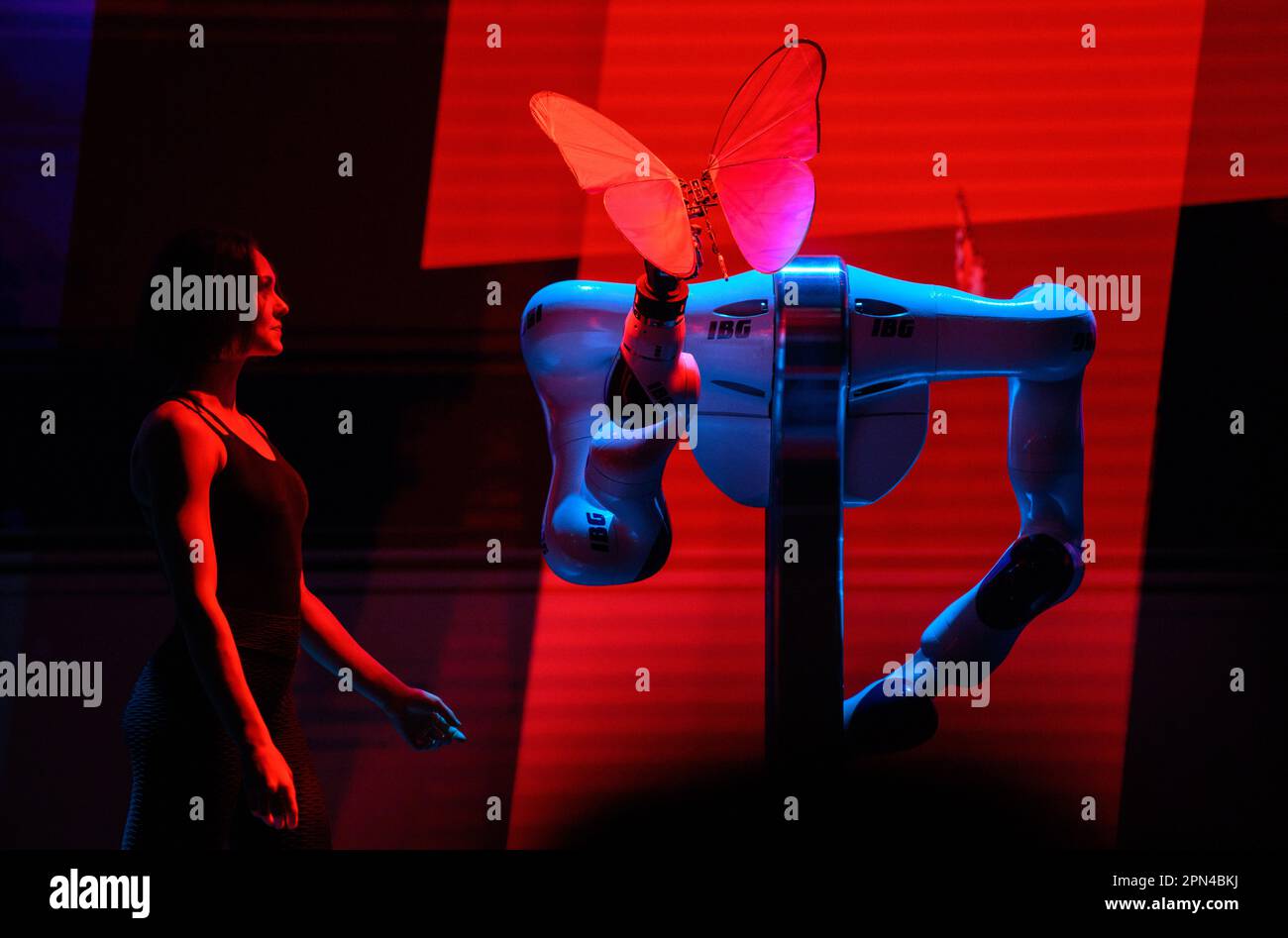 Hanover, Germany. 16th Apr, 2023. A dancer stands next to a robot with ...