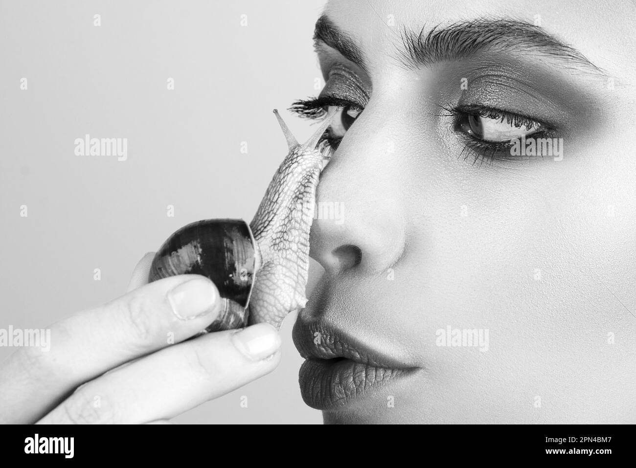 Cosmetology beauty procedure. Skin care. Massage with snail. Skincare ...