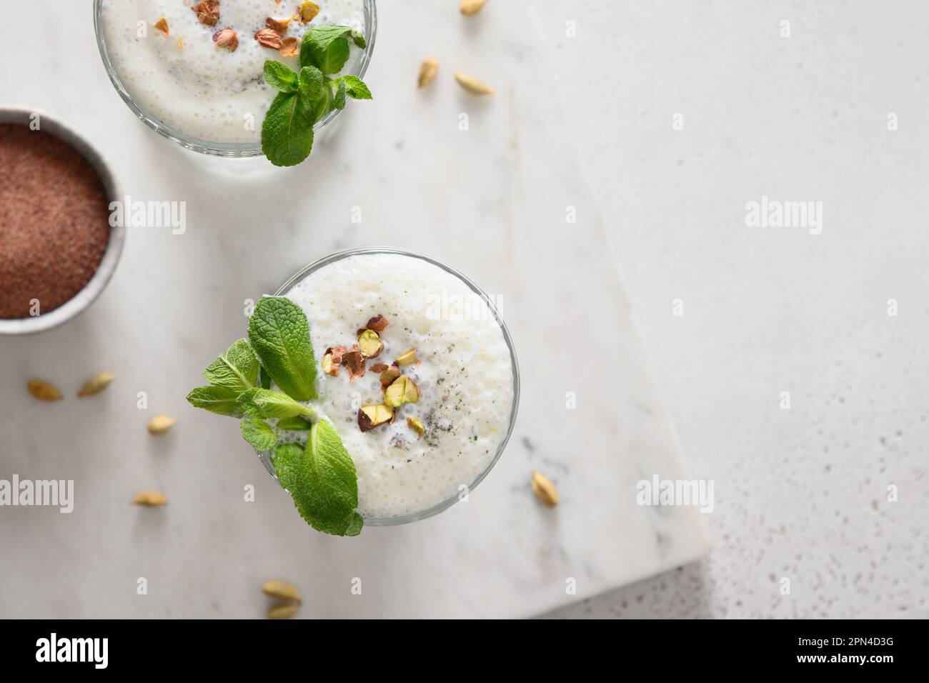 Indian Salty lassi with mint leaves and kala namak on white background ...