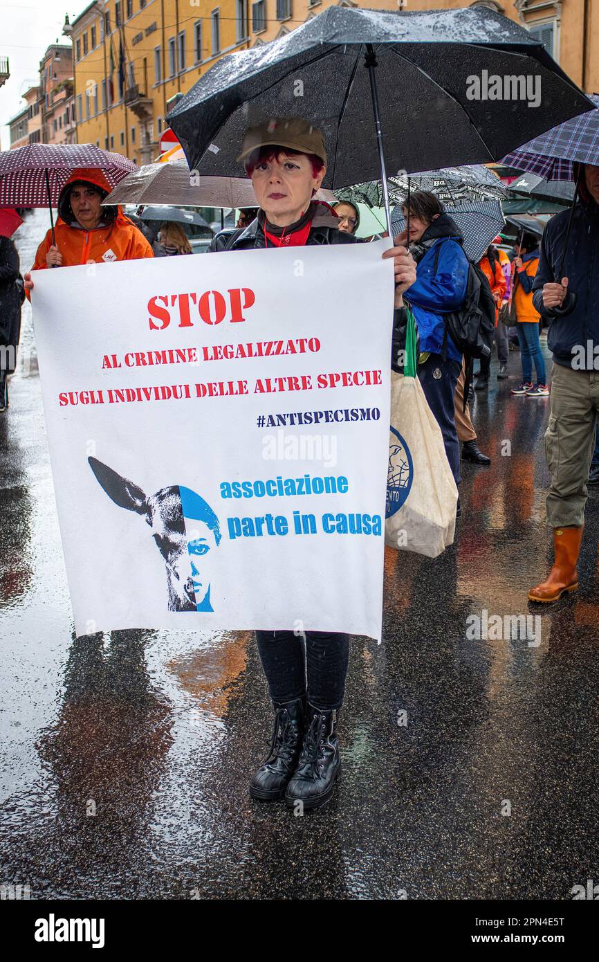 An animal rights activist holds a banner during the demonstration ...