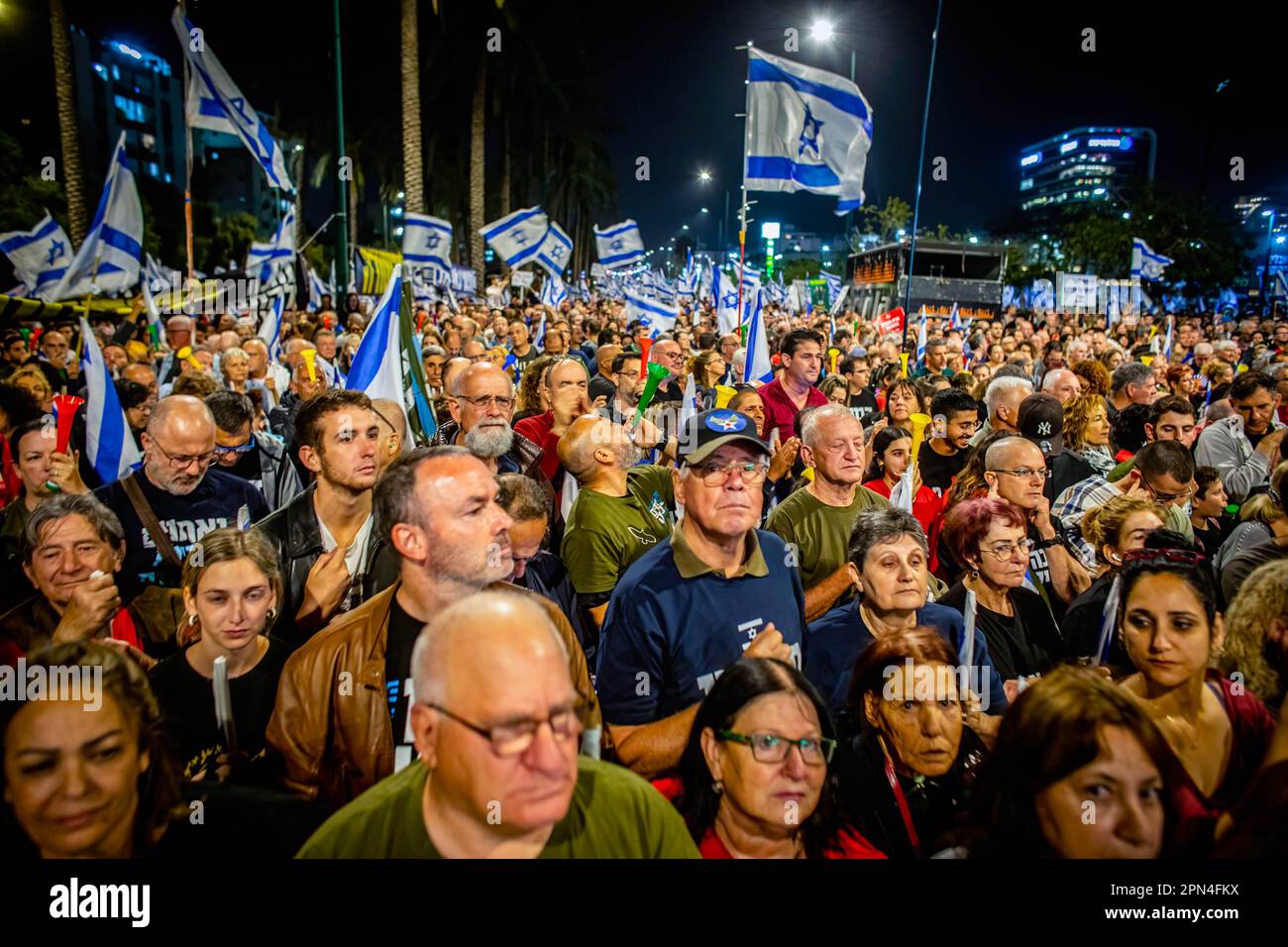 Netanya, Israel. 15th Apr, 2023. Israeli protestors hold flags during ...