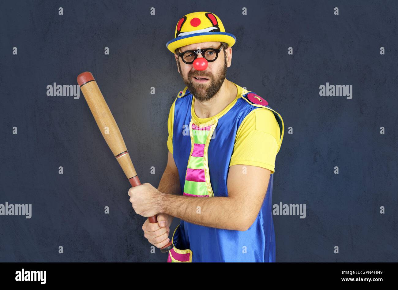 An insecure clown holds a bat in his hands Stock Photo - Alamy