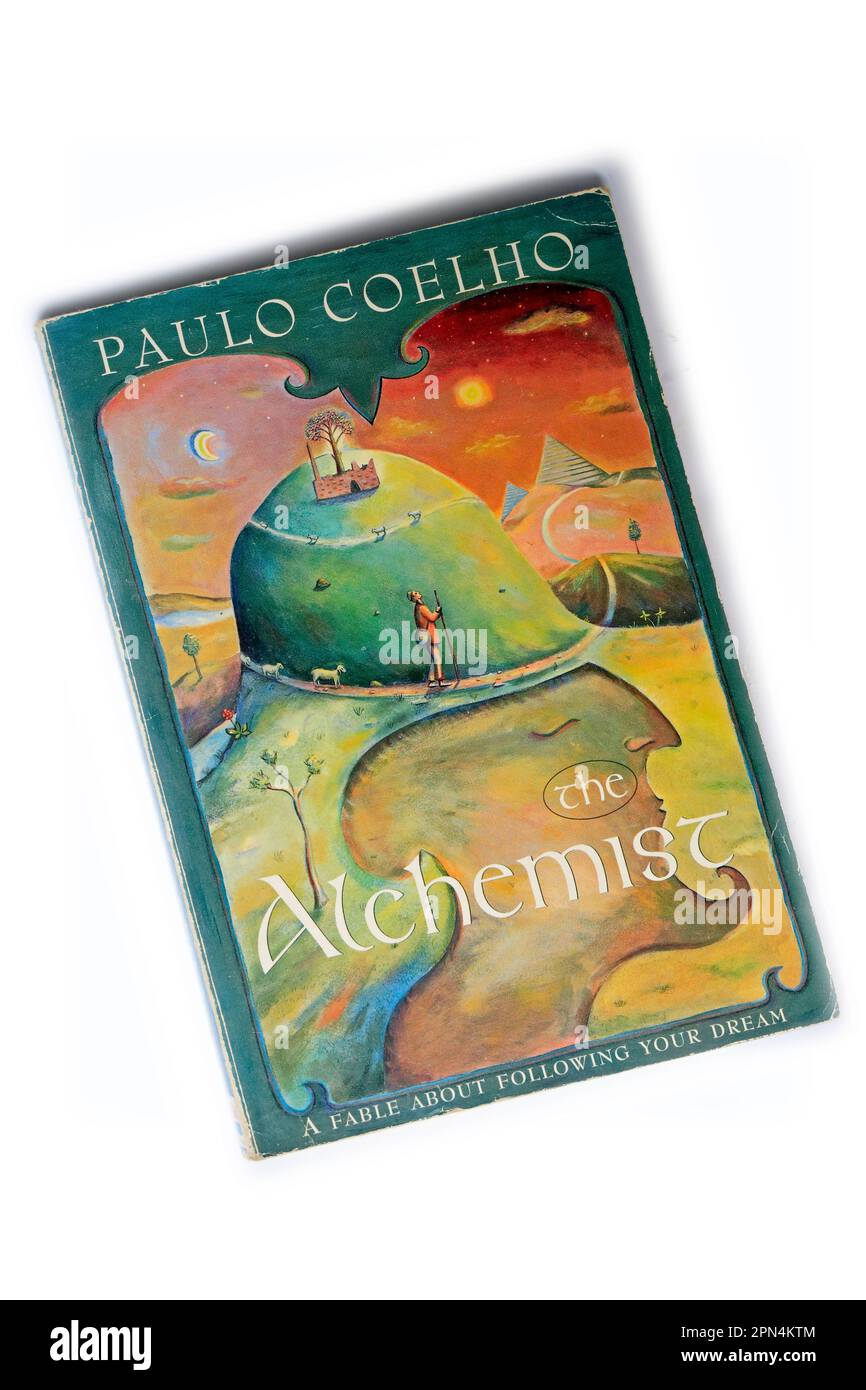 Paulo Coelho - The Alchemist - paperback book on white background ...