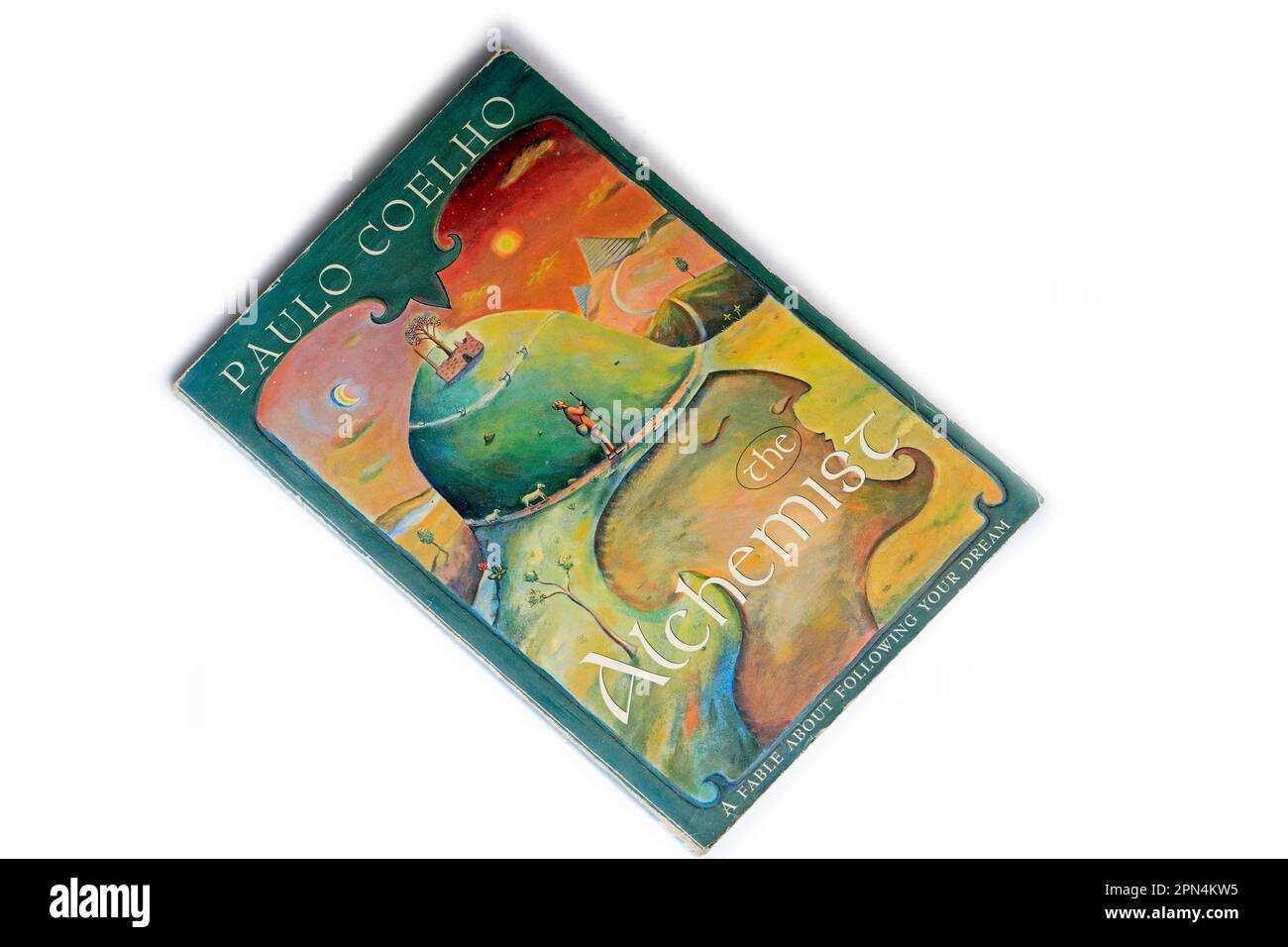 Paulo Coelho - The Alchemist - paperback book on white background ...