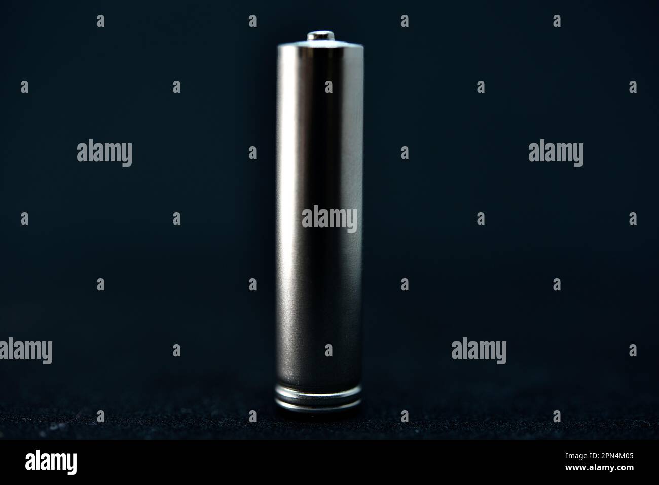 A shiny electric battery on a black background. The battery is a close ...