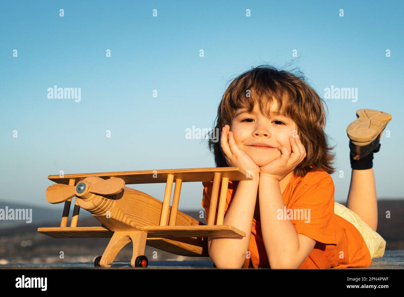 Funny child or kid little boy pilot play with toy airplane, startup ...