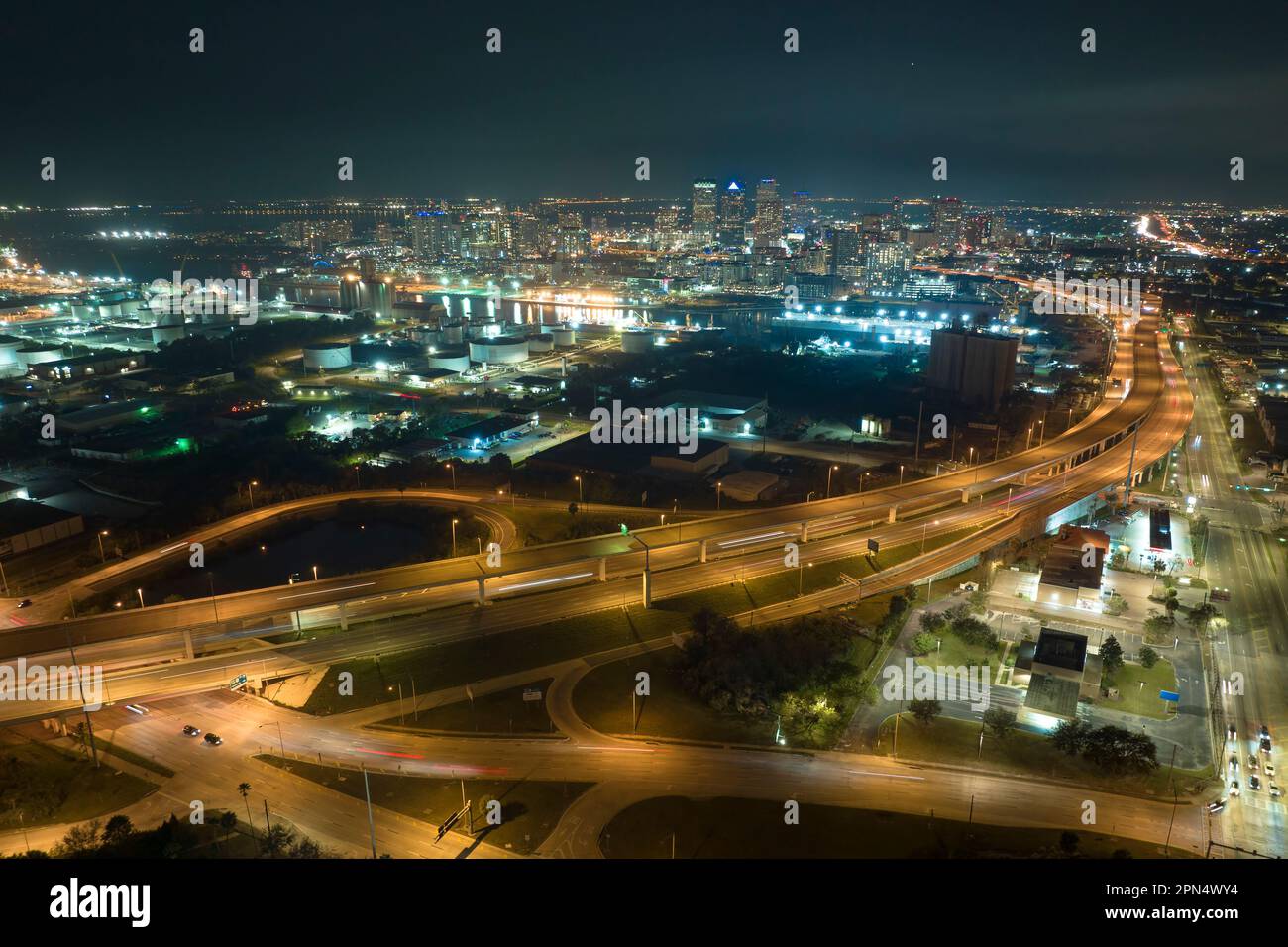 Aerial view of american freeway intersection at night with fast driving ...