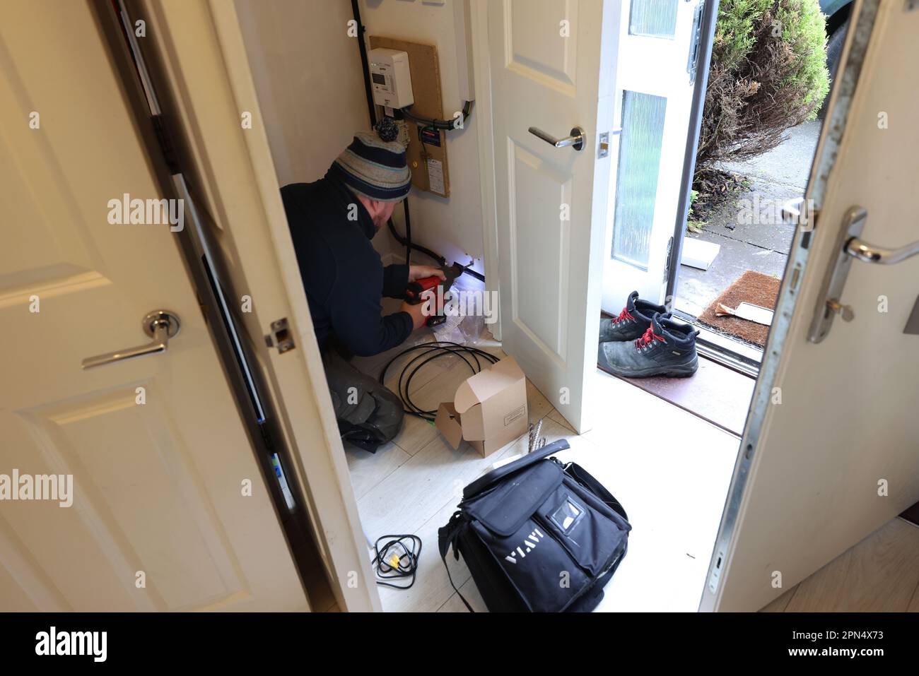 A BT Openreach man pictured installing Fibre Optic Broadband into a ...