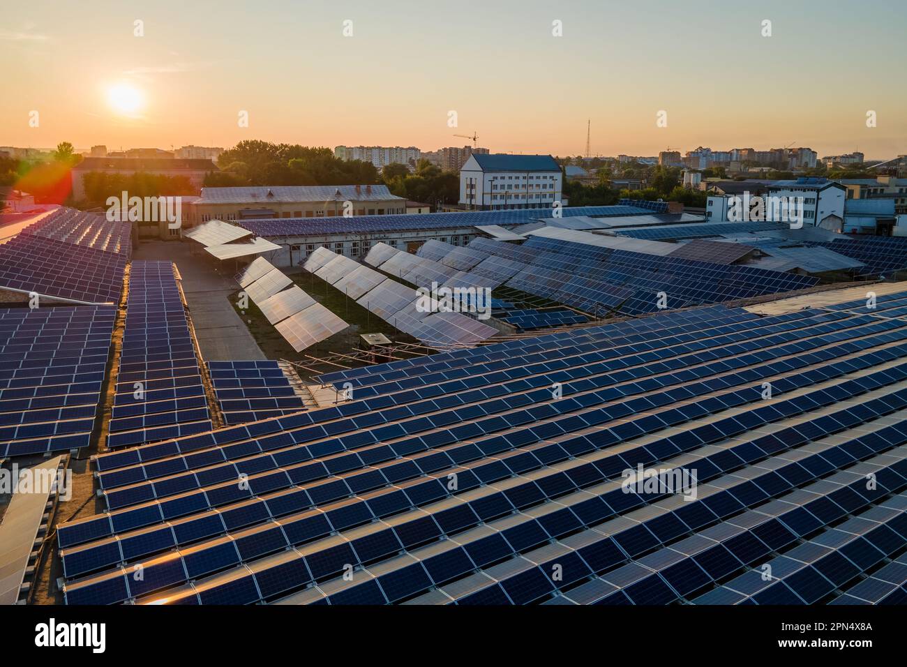 Aerial view of blue photovoltaic solar panels mounted on industrial ...