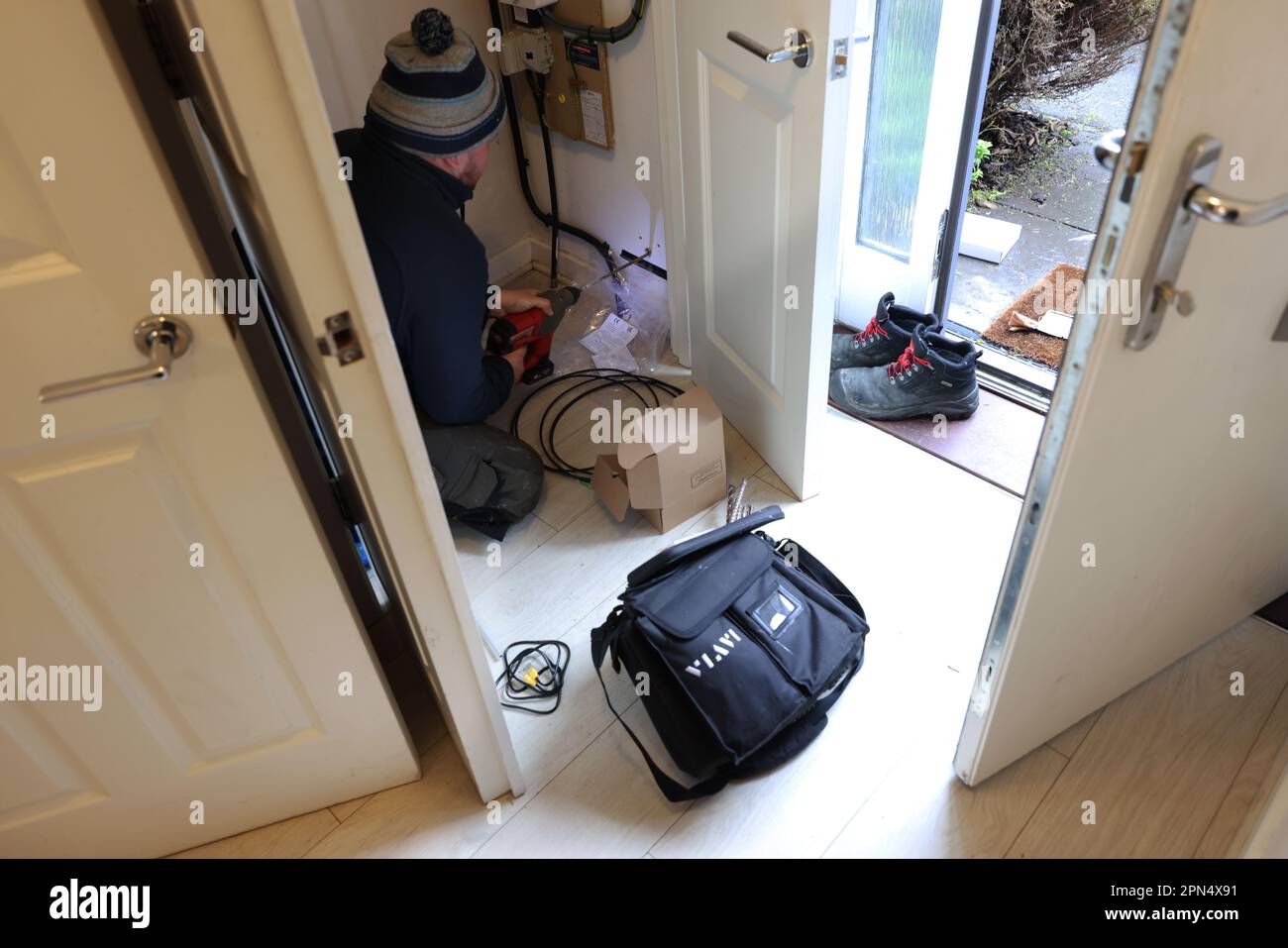 A BT Openreach man pictured installing Fibre Optic Broadband into a ...