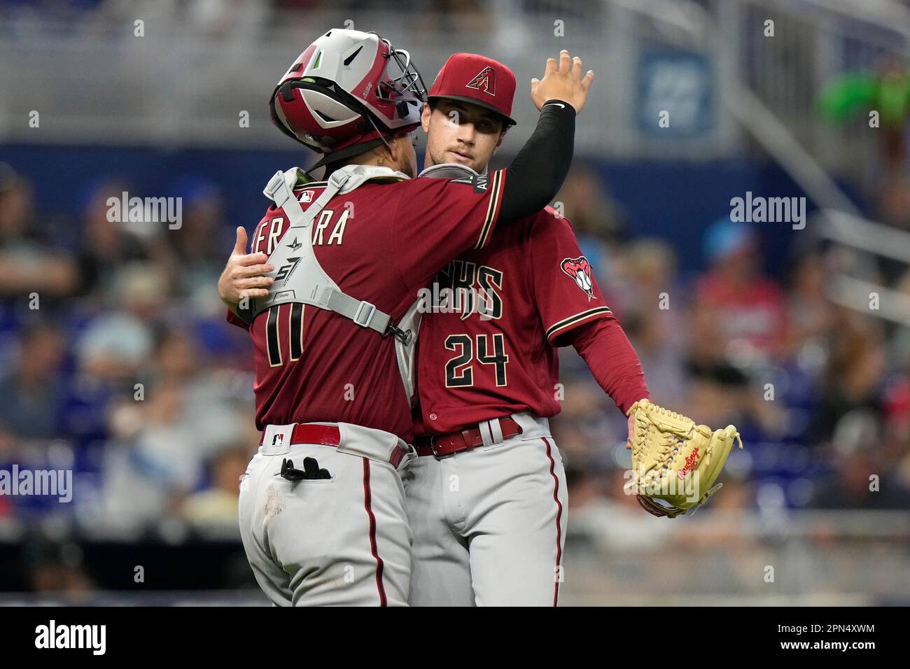 Arizona Diamondbacks catcher Jose Herrera (11) and relief pitcher Kyle ...
