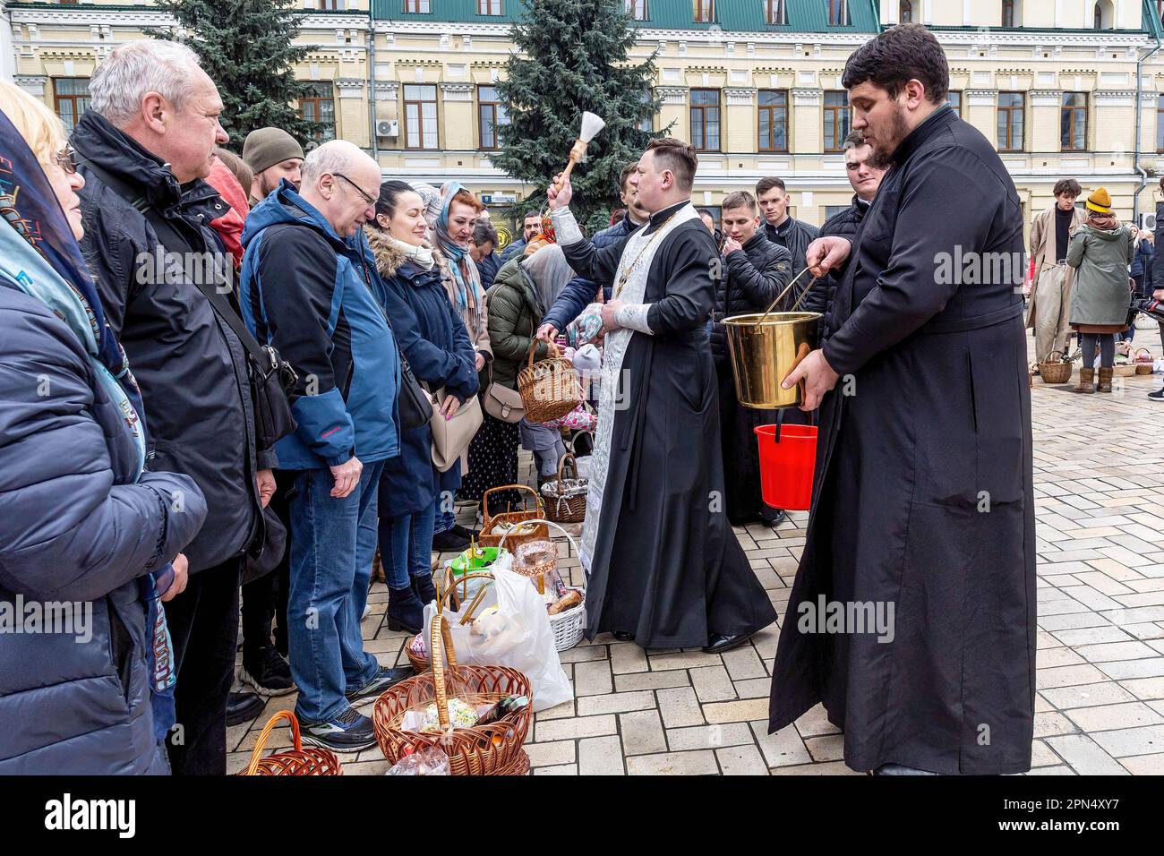 A priest blesses Easter food with Holy Water as Ukrainian believers ...