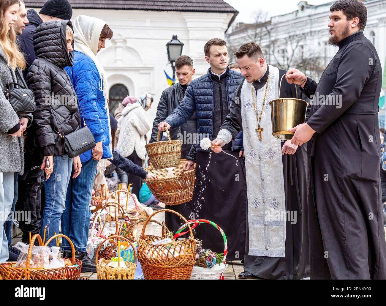 A priest blesses Easter food with Holy Water as Ukrainian believers ...