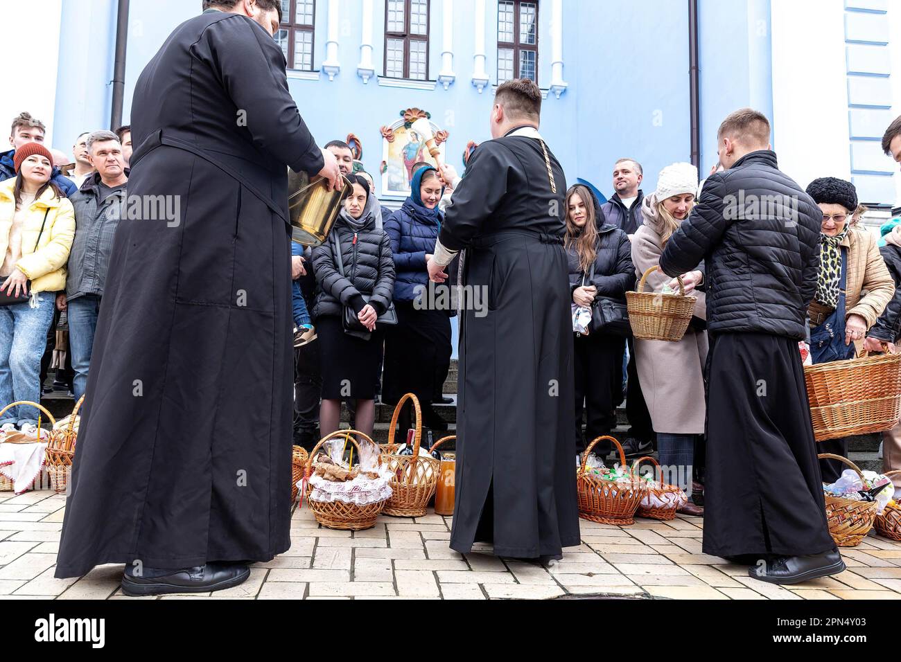 A priest blesses Easter food with Holy Water as Ukrainian believers ...