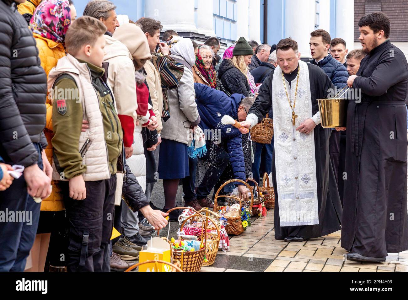 A priest blesses Easter food with Holy Water as Ukrainian believers ...