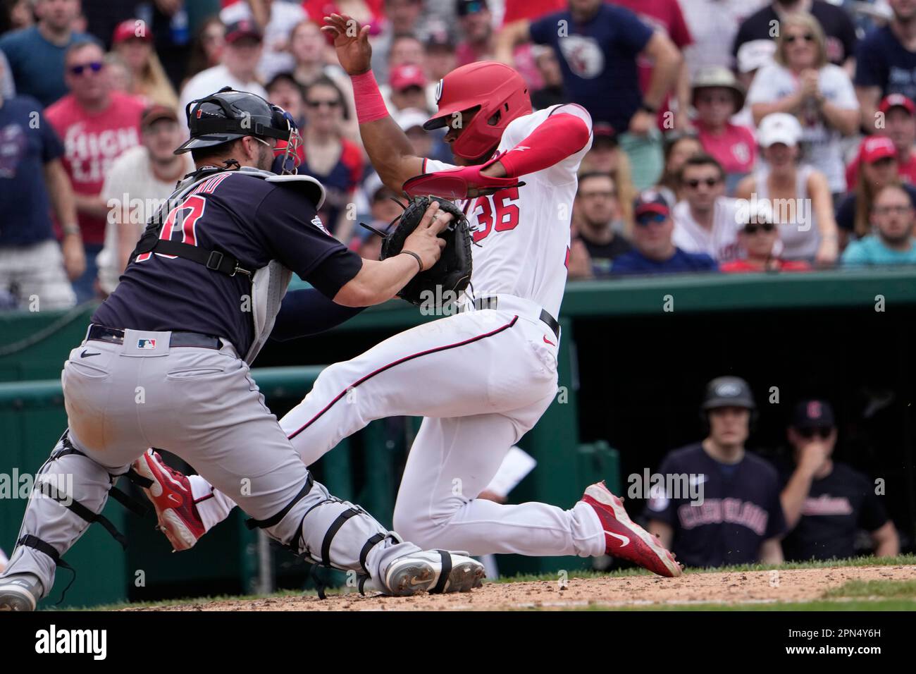 Washington Nationals Stone Garrett, right, slides safely into home plate, beating a tag by ...