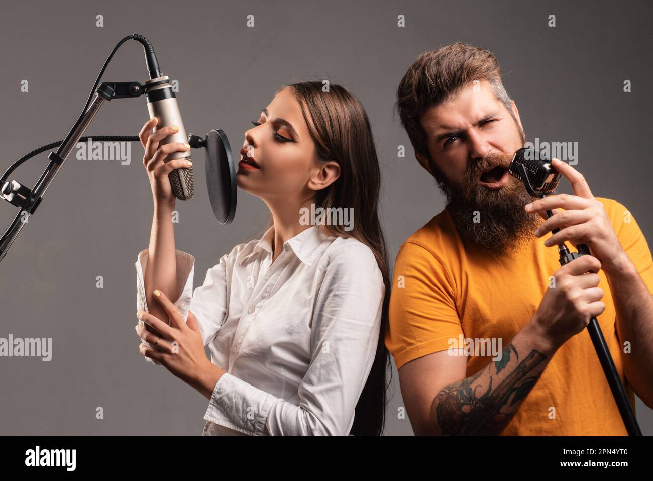 Karaoke singers couple. Woman and man singing with music microphone ...