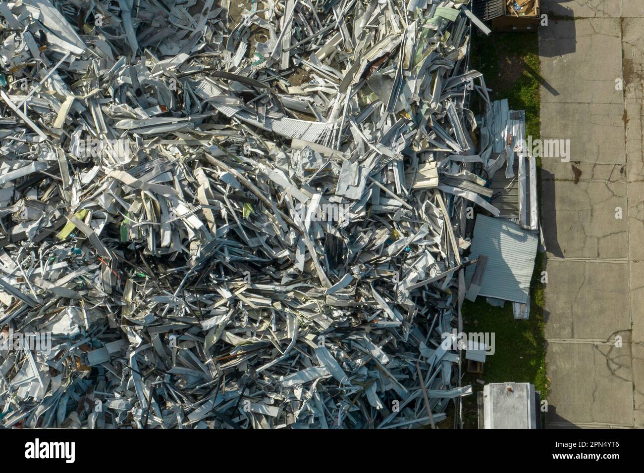 Aerial view of large pile of scrap aluminum metal from broken houses ...