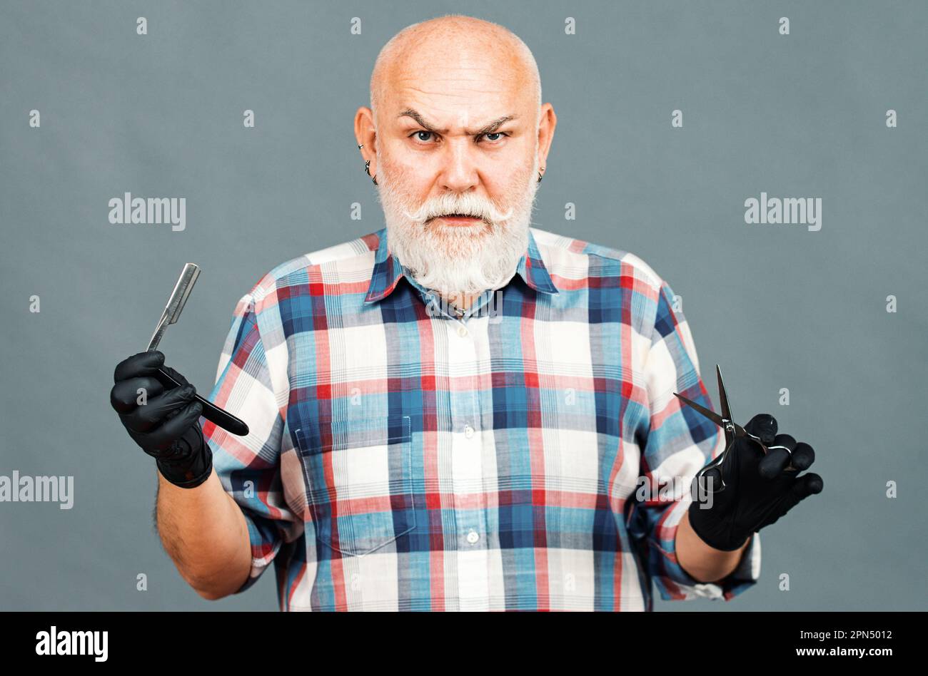 Barbershop concept. Bearded senior man hairdresser in barber shop ...