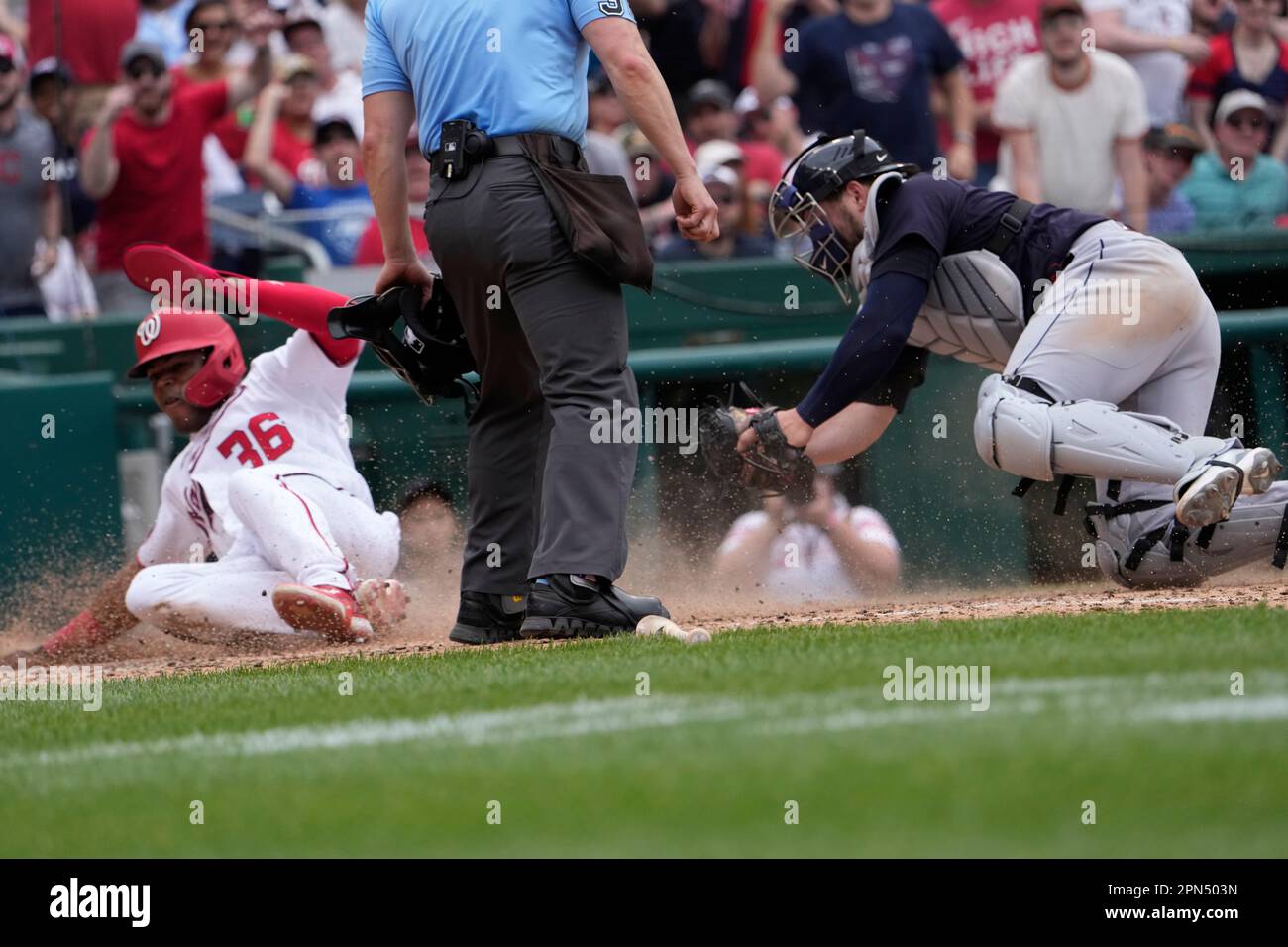 Washington Nationals' Stone Garrett (36) slides safely into home plate ...