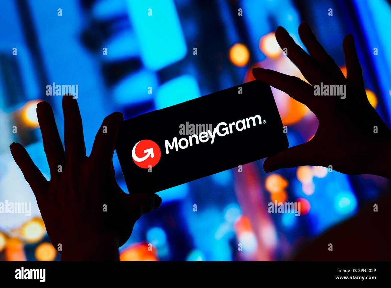 In this photo illustration, the MoneyGram logo is displayed on a ...