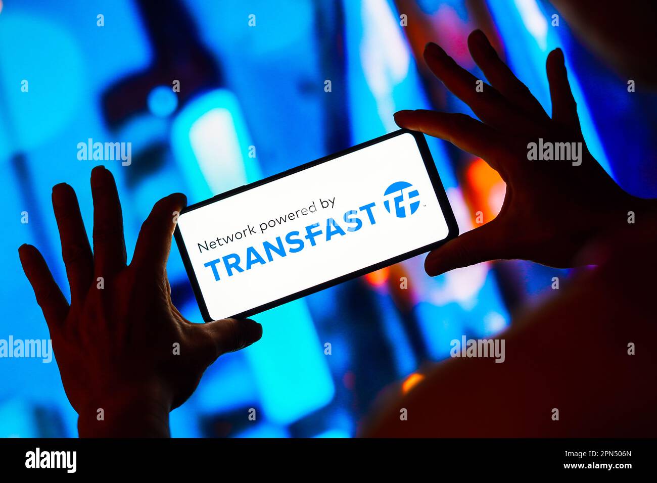 In this photo illustration, the Transfast logo is displayed on a ...