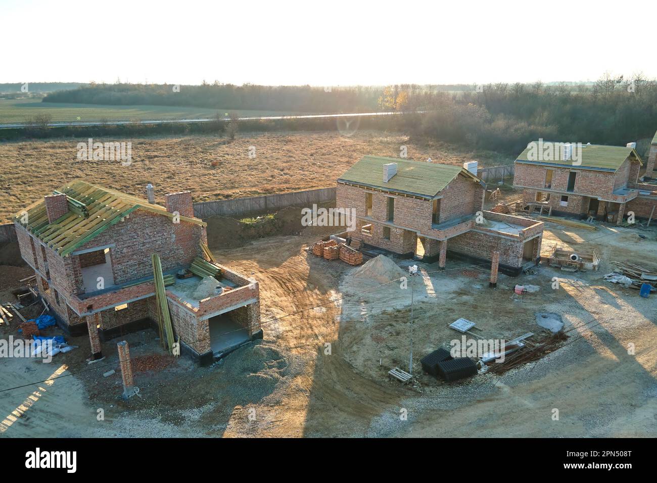 Aerial view of new homes with brick framework walls under construction ...