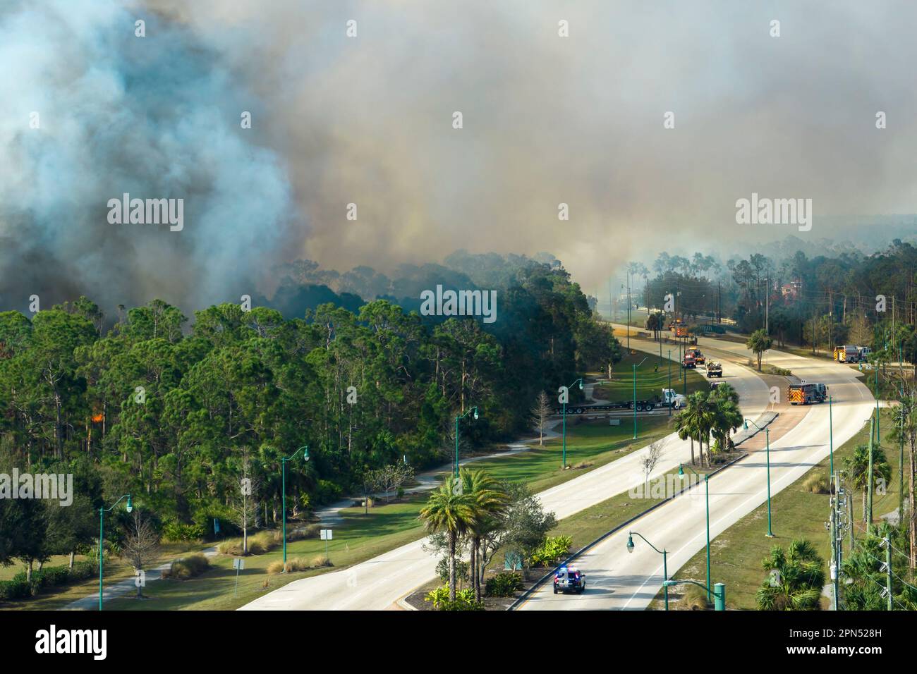 Fire department firetrucks extinguishing wildfire burning severely in ...