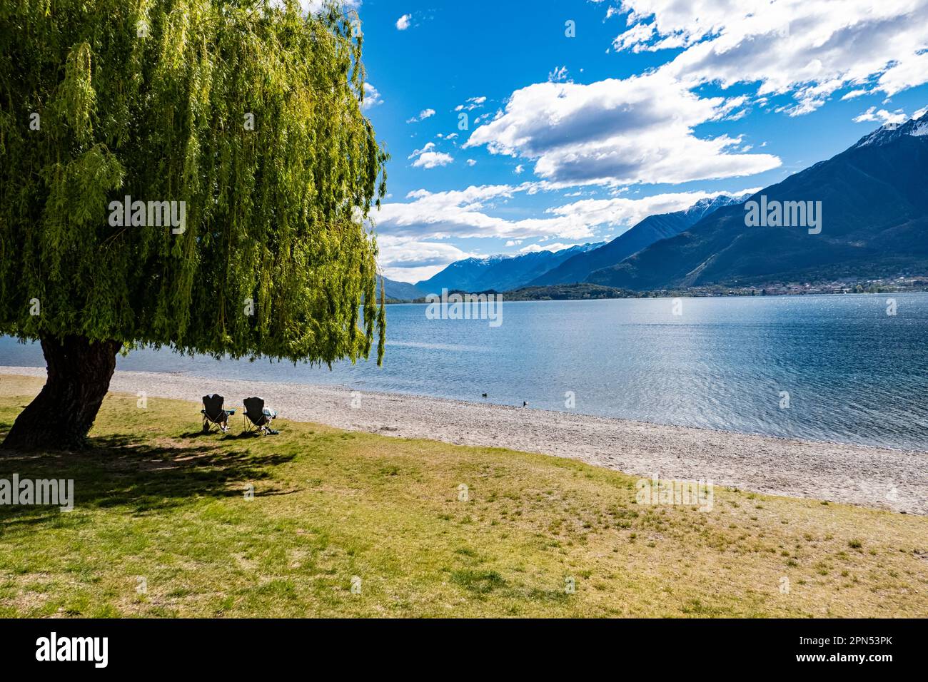 Relaxation scene on a beach of Lake Como Stock Photo - Alamy