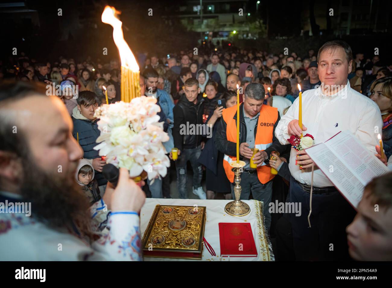 Pr. Daniel officiating the religious ceremony with the faithful who ...