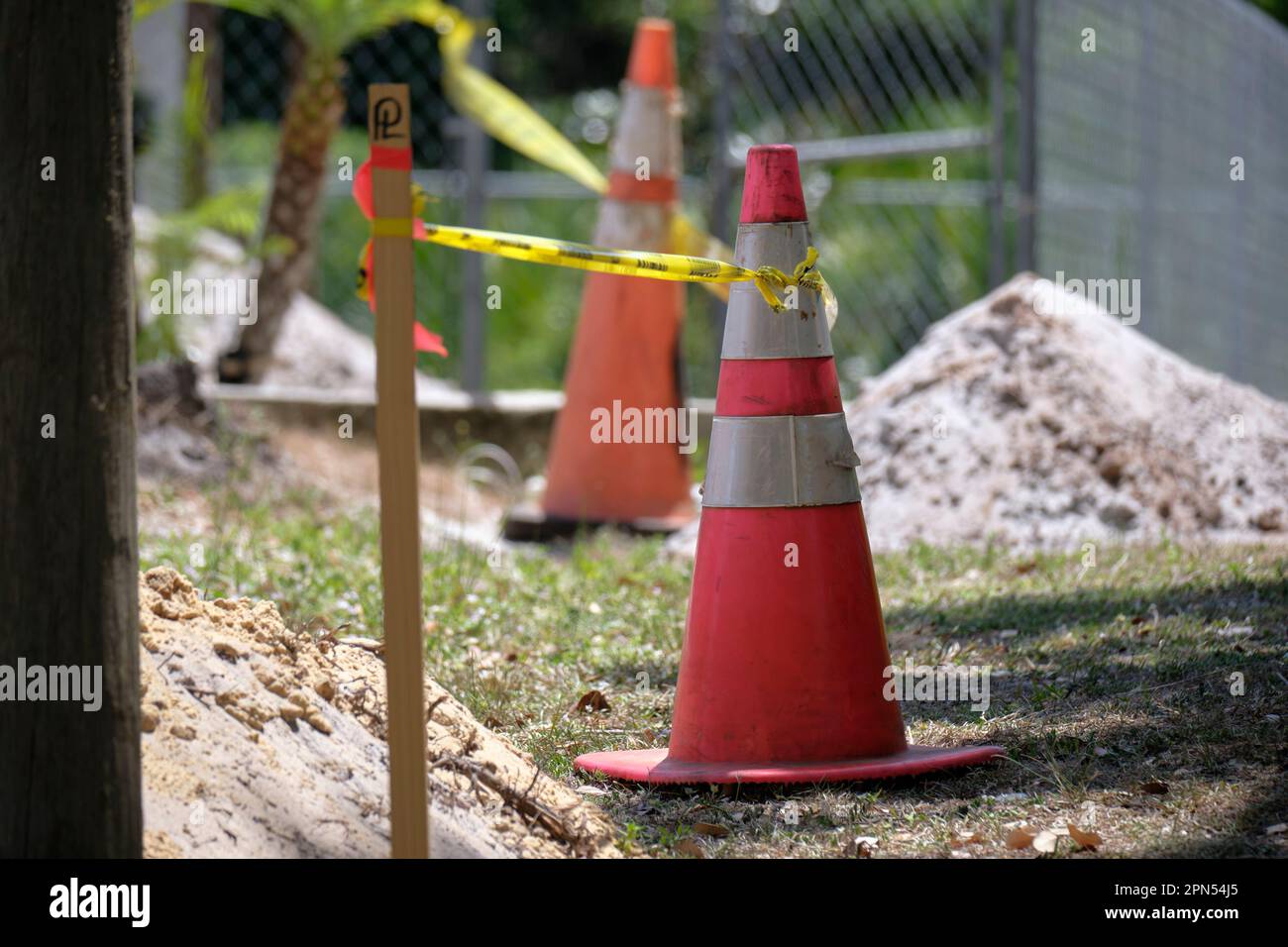 Yellow warning cones and tape as protective restriction barrier at ...