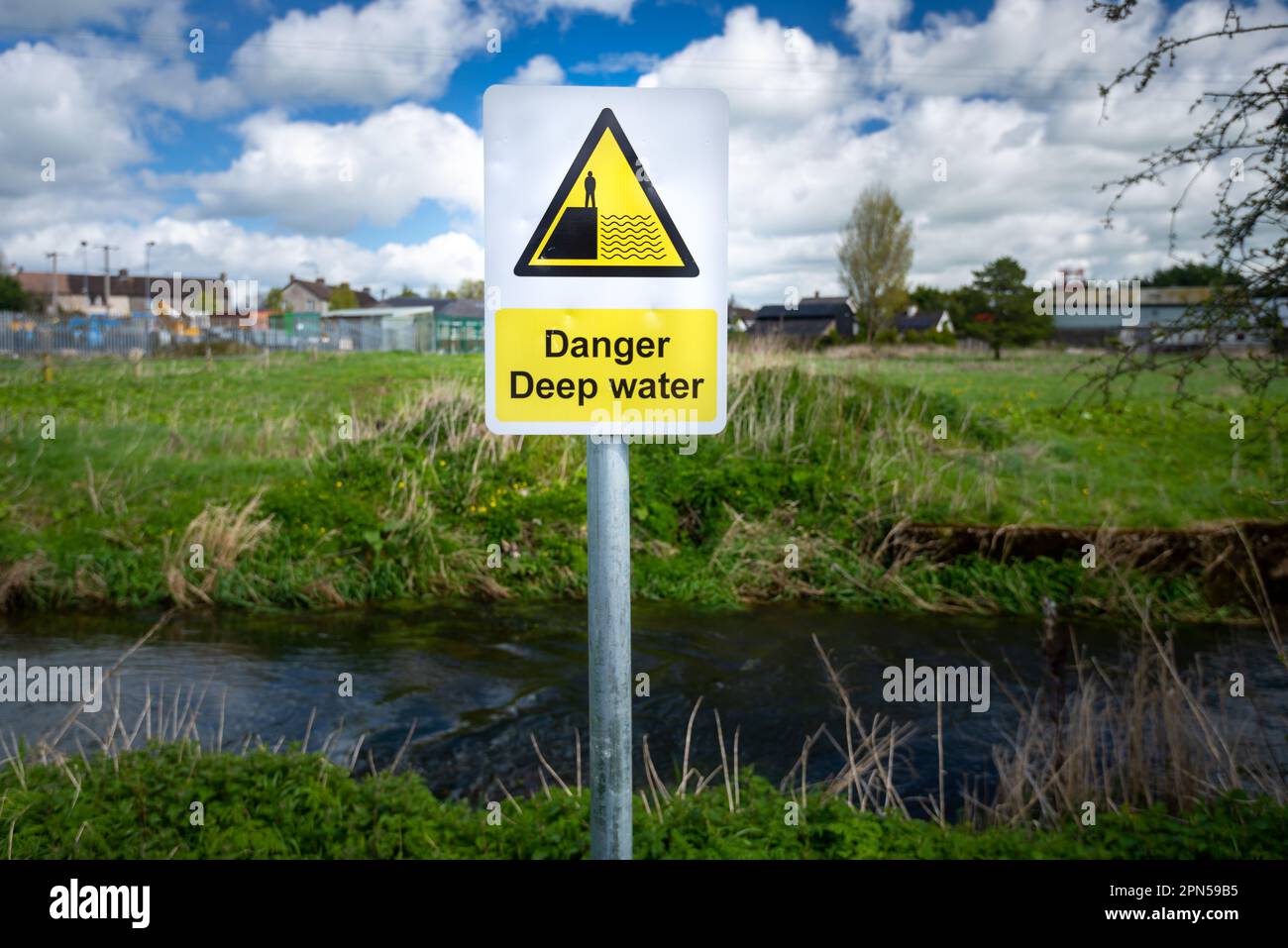 Danger Deep Water warning sign on rural river bank. Risk of falling in ...