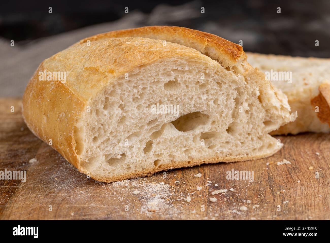slices of sliced loaf of wheat bread, a loaf of fresh bread cut into ...