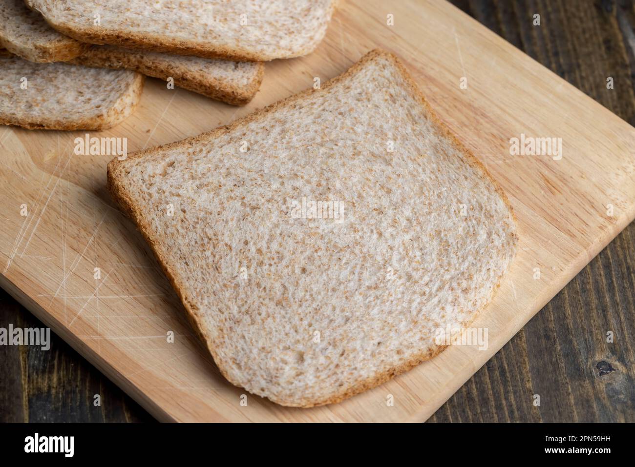 Square loaf of light wheat bread cut into pieces, sliced wheat bread ...