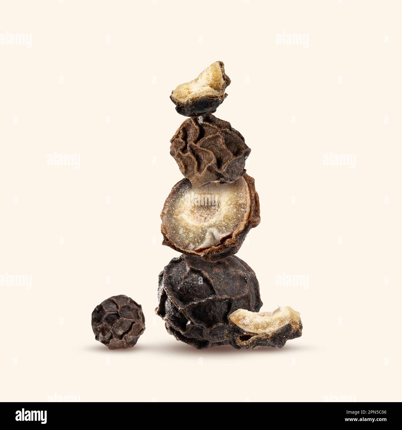 Close-up of a stack of Organic dried black pepper seeds, whole and ...