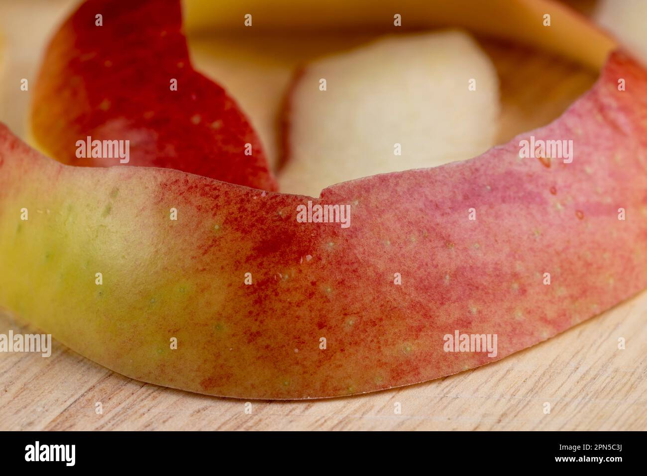 Peel and slice ripe red apples, delicious apples and their peel while ...