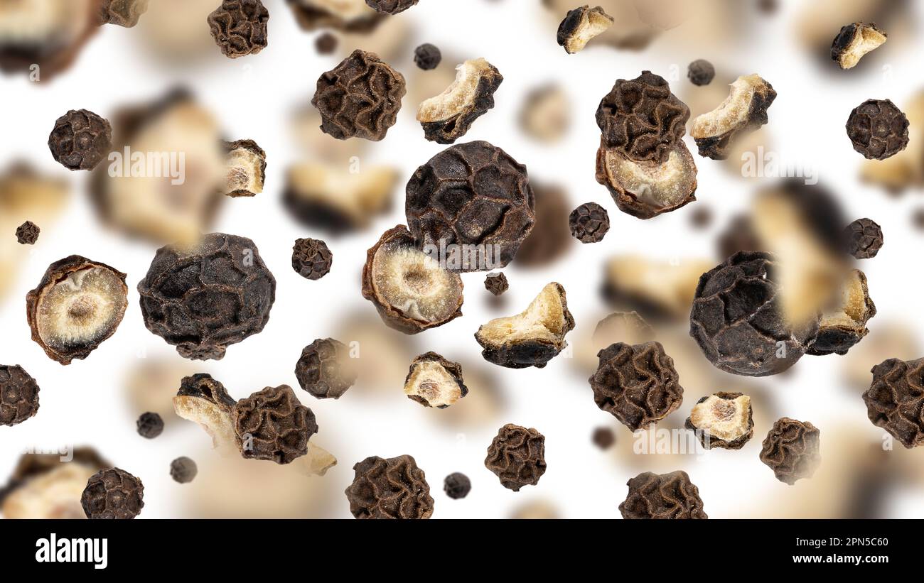Organic peppercorn, whole and sliced, flying on white background ...