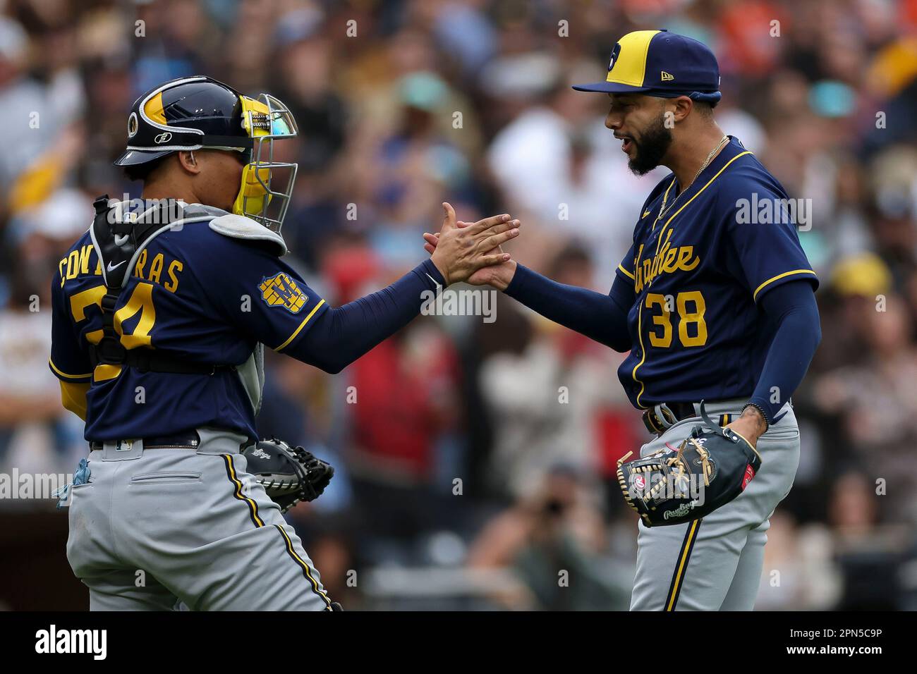 Milwaukee Brewers catcher William Contreras, left, congratulates relief ...