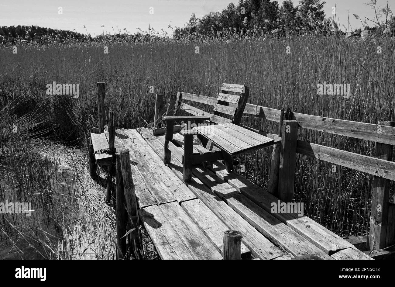 an old wooden bridge with a seat and table Stock Photo - Alamy