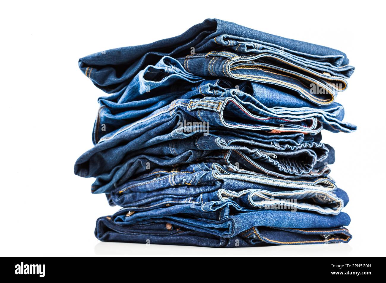 Stack of blue jeans on white Stock Photo - Alamy