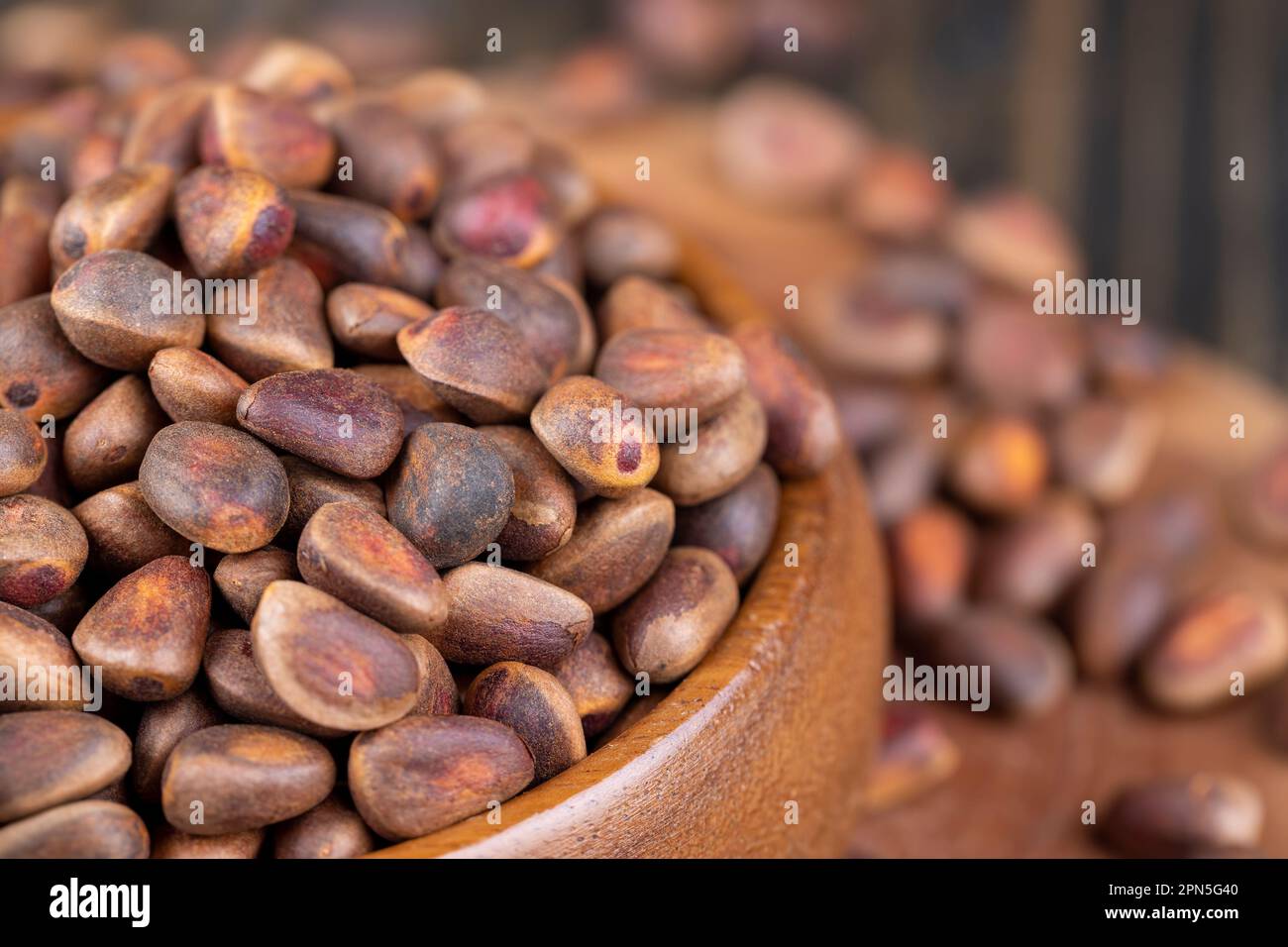 Unpeeled pine nuts on the table, a bunch of pine nuts in the shell ...