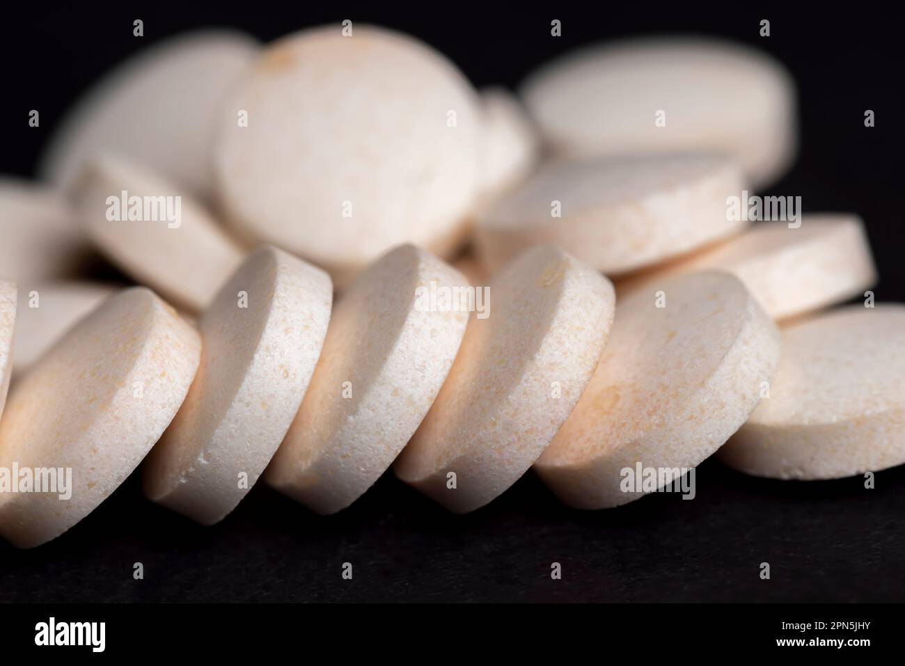 Open and unpacked tablets close-up, a large number of identical medical ...