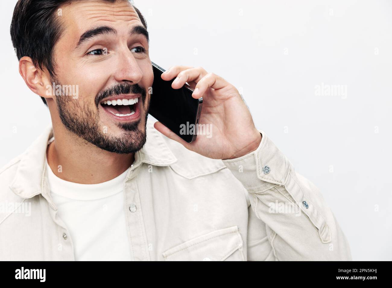 Closeup portrait man talking on the phone smile with teeth happiness ...