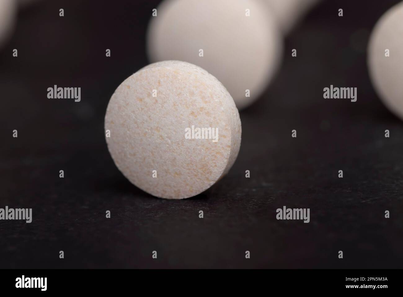 Open and unpacked tablets close-up, a large number of identical medical ...