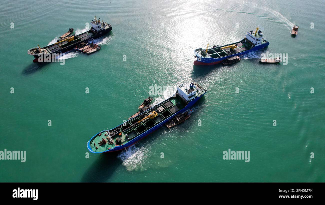 RONGCHENG, CHINA- APRIL 16, 2023 - Fishermen carry cages filled with ...