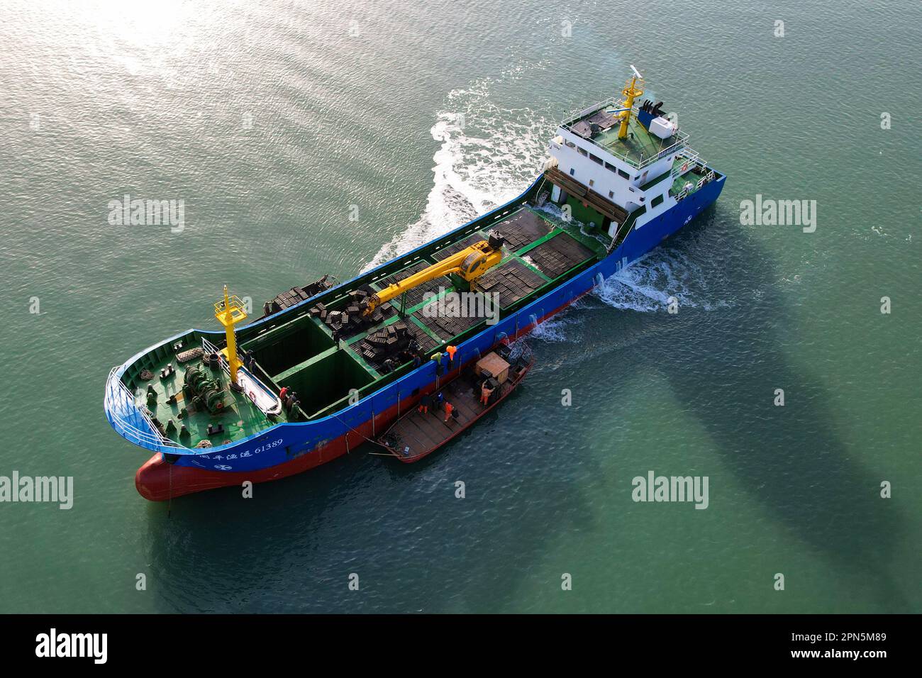 RONGCHENG, CHINA- APRIL 16, 2023 - Fishermen carry cages filled with ...