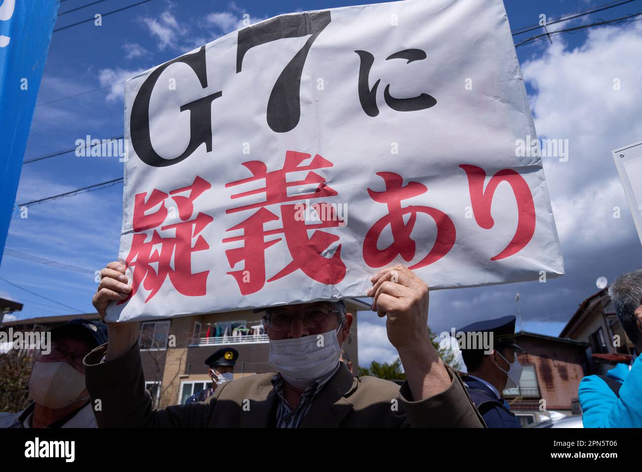 Karuizawa, Japan. 16th Apr, 2023. A protester holding a placard is ...